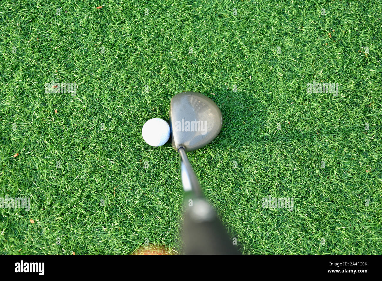 Stick with a ball on an artificial golf course Stock Photo - Alamy
