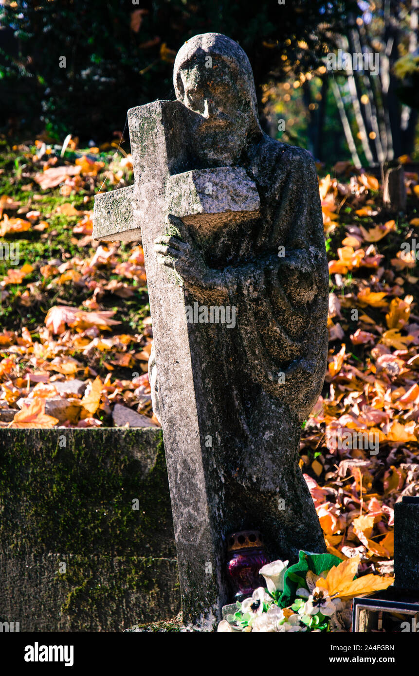 old stone statue of saint with cross Stock Photo - Alamy
