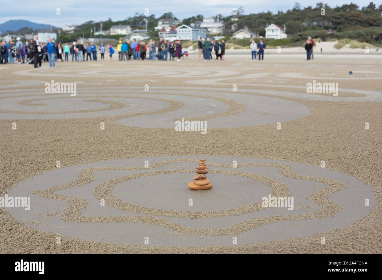 People walking a sand labyrinth at Heceta Beach in Florence, Oregon ...