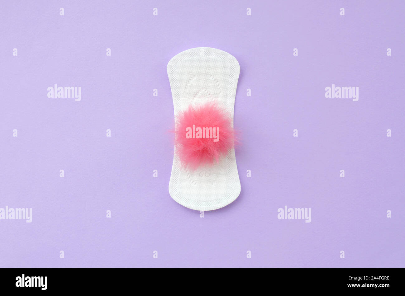 Menstrual pad and red fluffy fuzzy as a blood on violet pastel ...