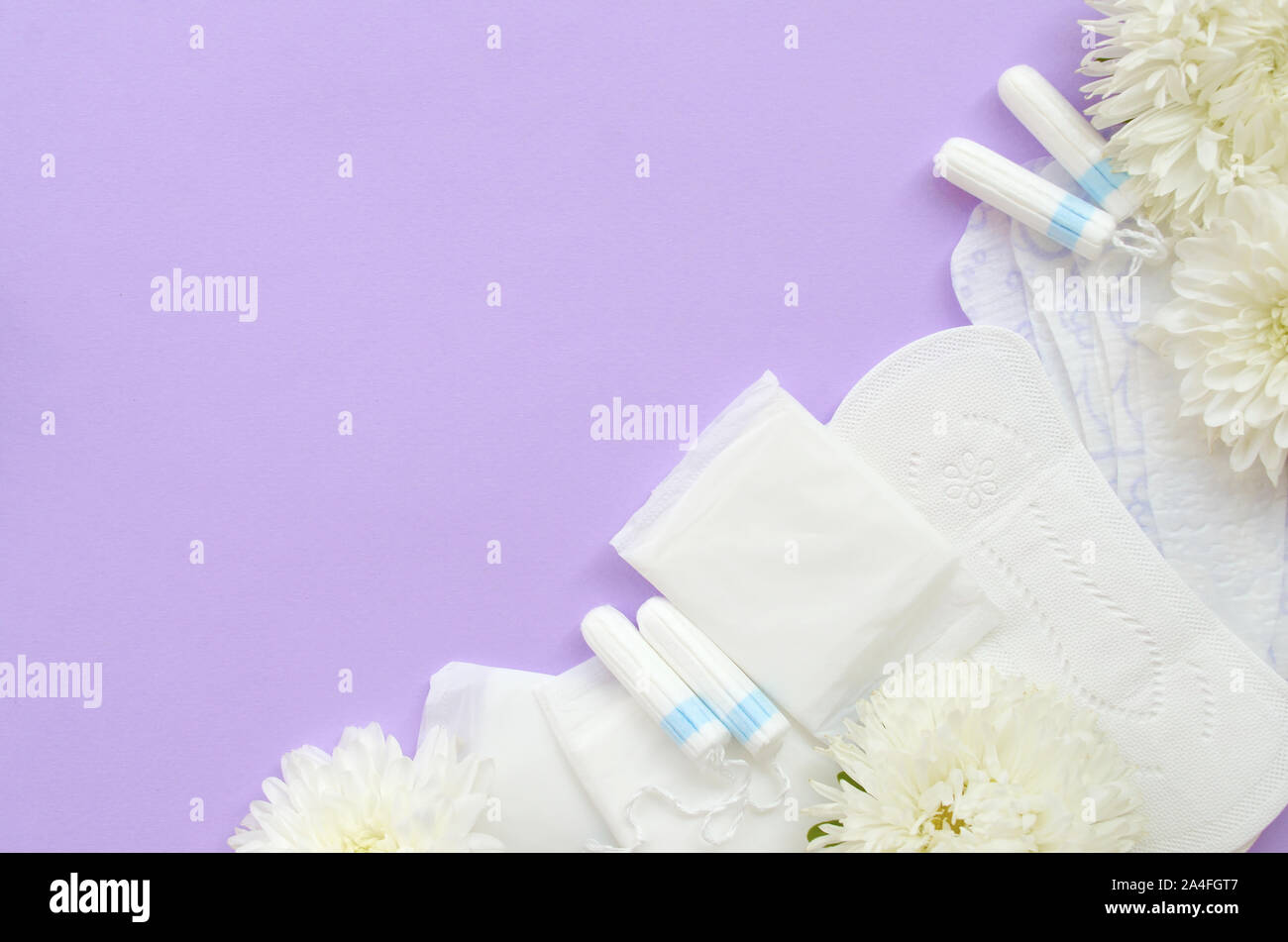 Menstrual pads and tampons with tender white flowers on pastel lilac ...