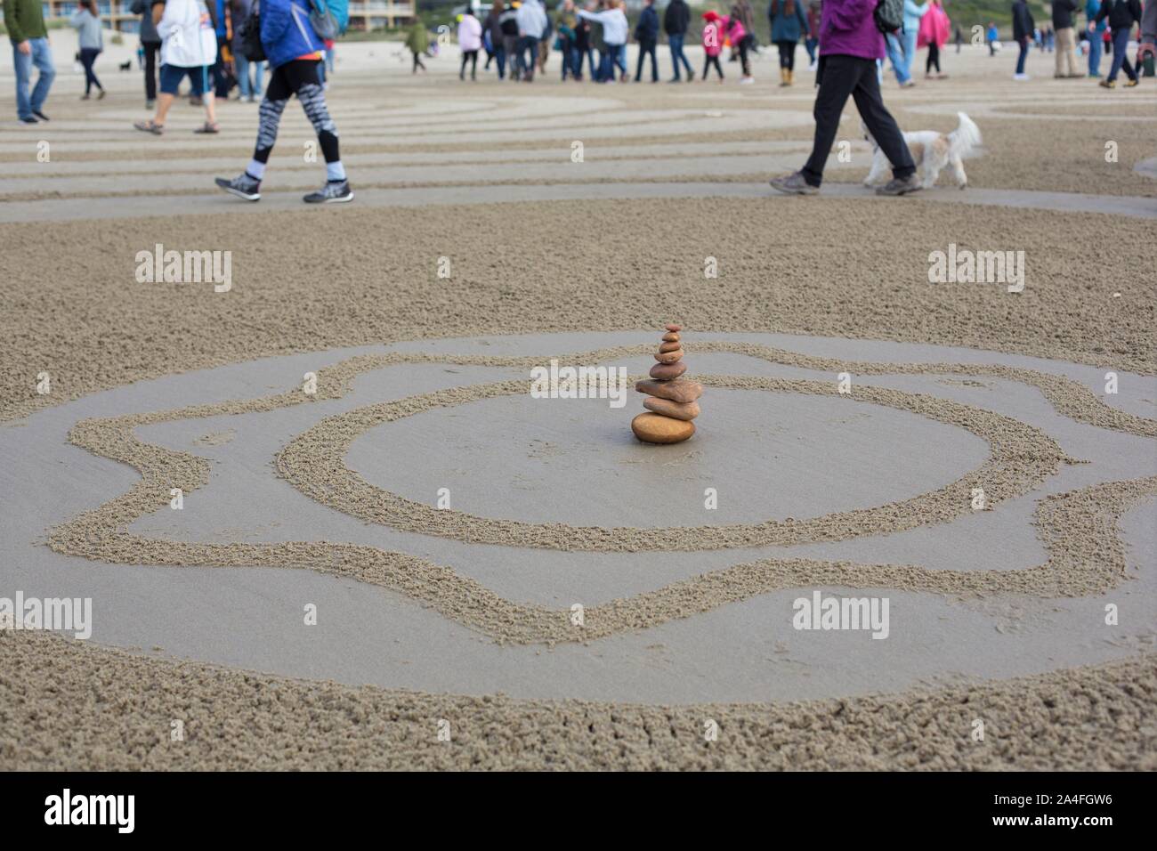 People walking a sand labyrinth at Heceta Beach in Florence, Oregon ...