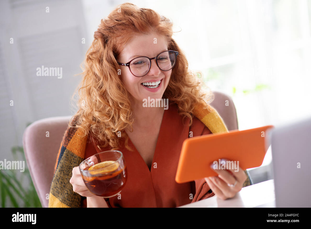 Woman in glasses feeling better after drinking tea Stock Photo - Alamy