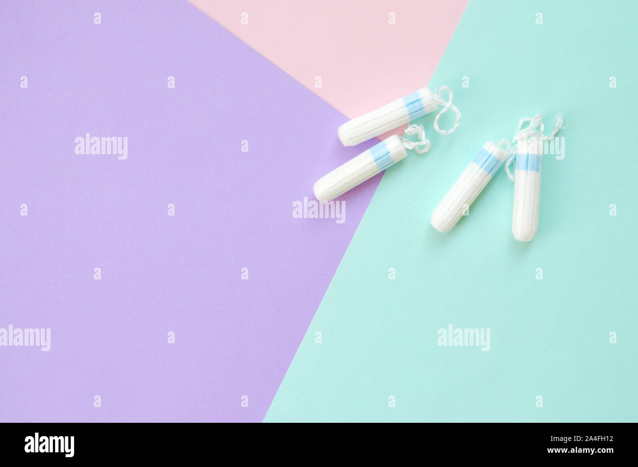 Flat lay composition with menstrual tampons on blue pink and lilac ...