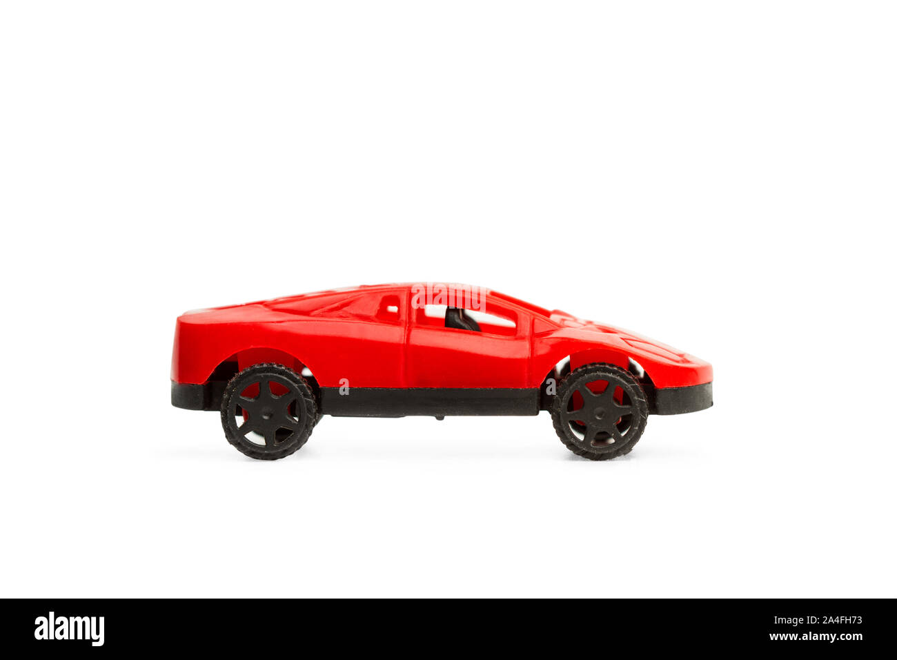 A little plastic red toy car on a white background Stock Photo - Alamy