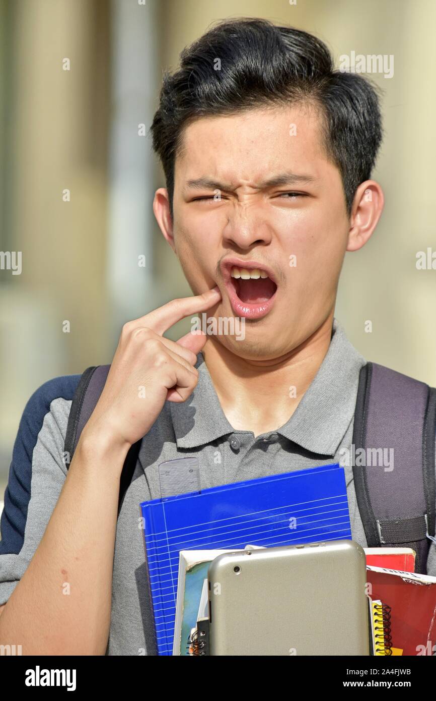 Male Student With Toothache With Books Stock Photo - Alamy