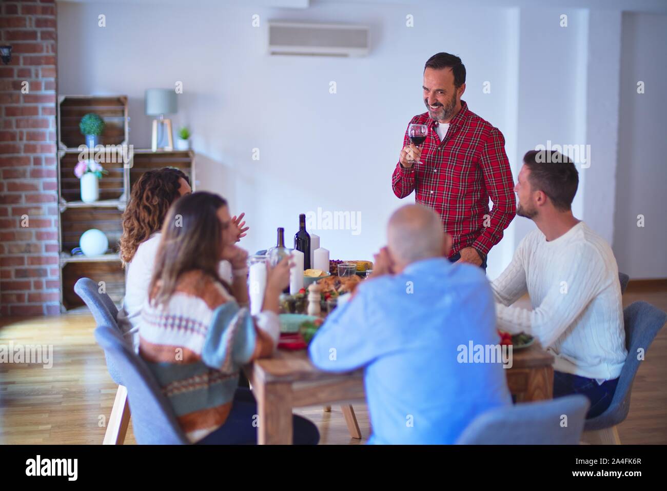 Beautiful family smiling happy and confident. Man speaking speech with ...