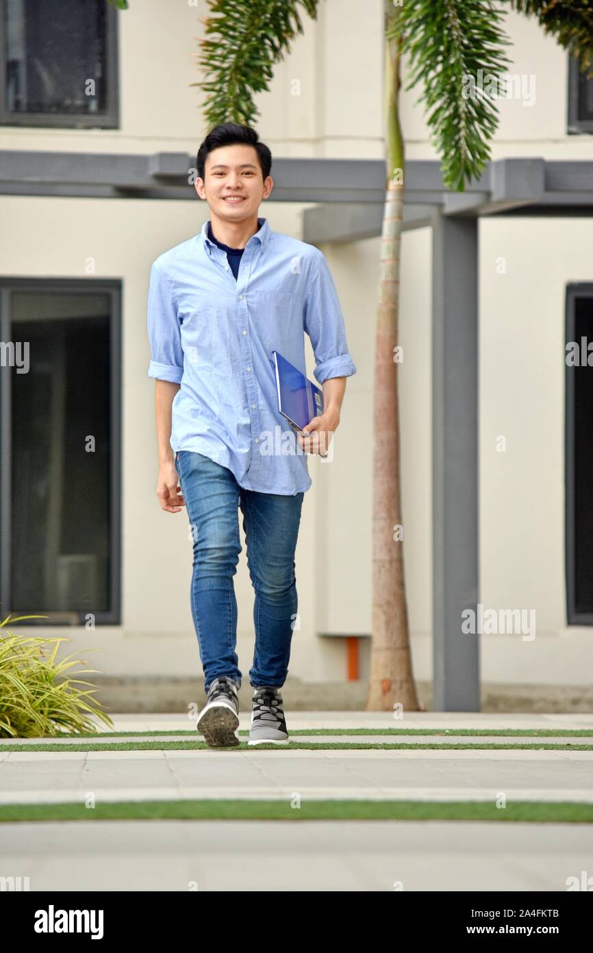 Attractive Boy Student Walking On Campus Stock Photo - Alamy