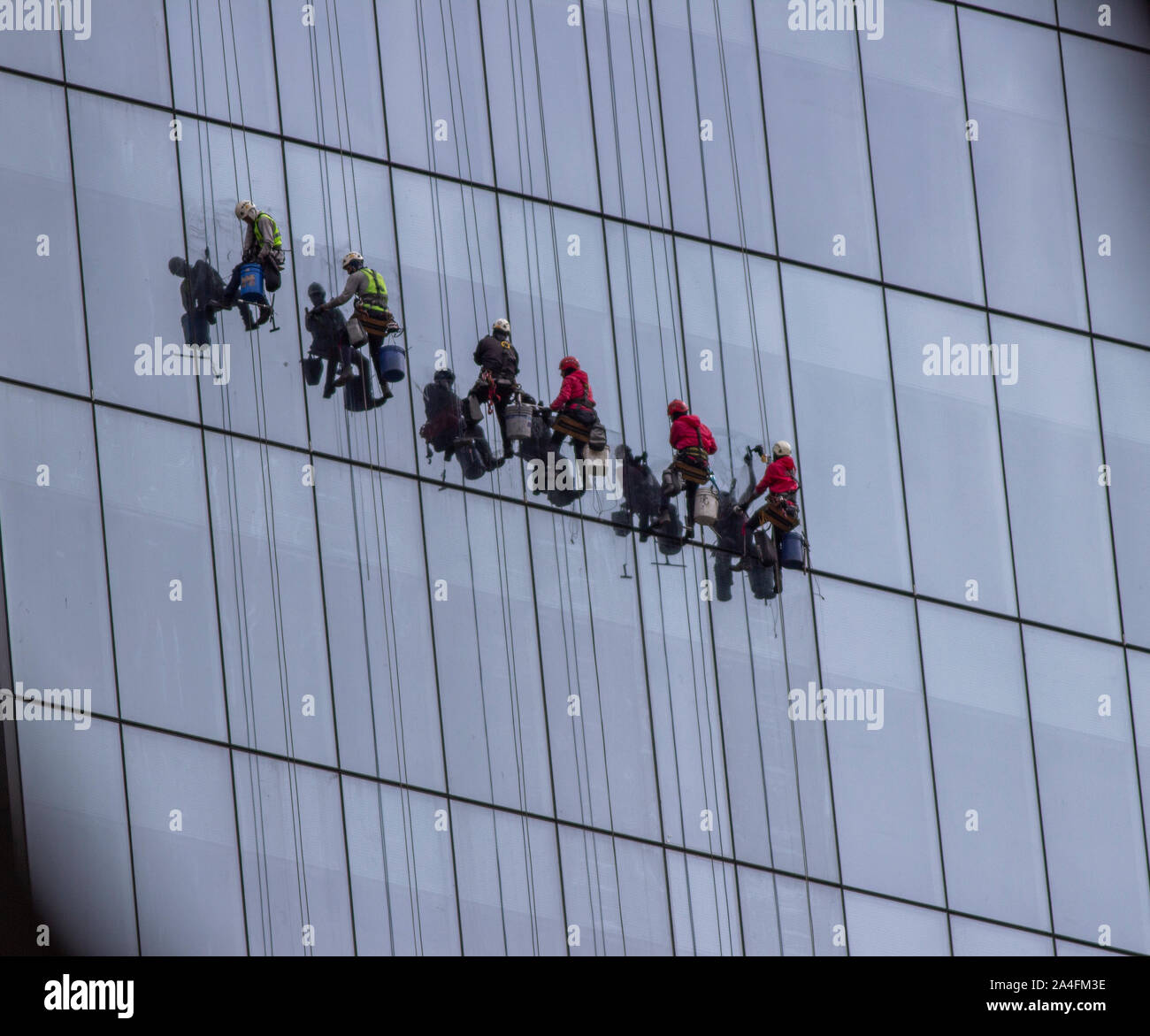 People washing the windows of a building Stock Photo - Alamy