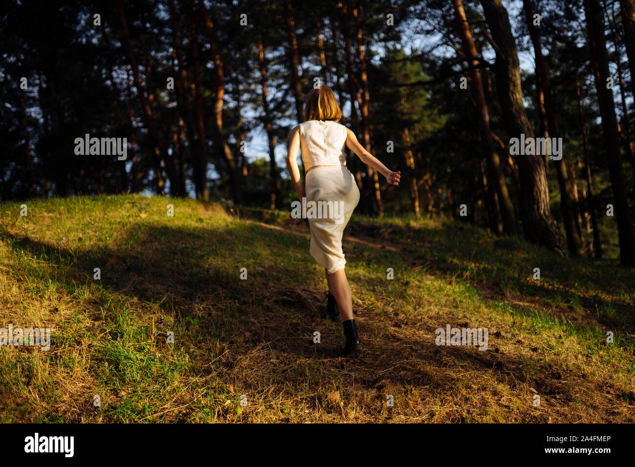 woman runs in the forest back view Stock Photo - Alamy