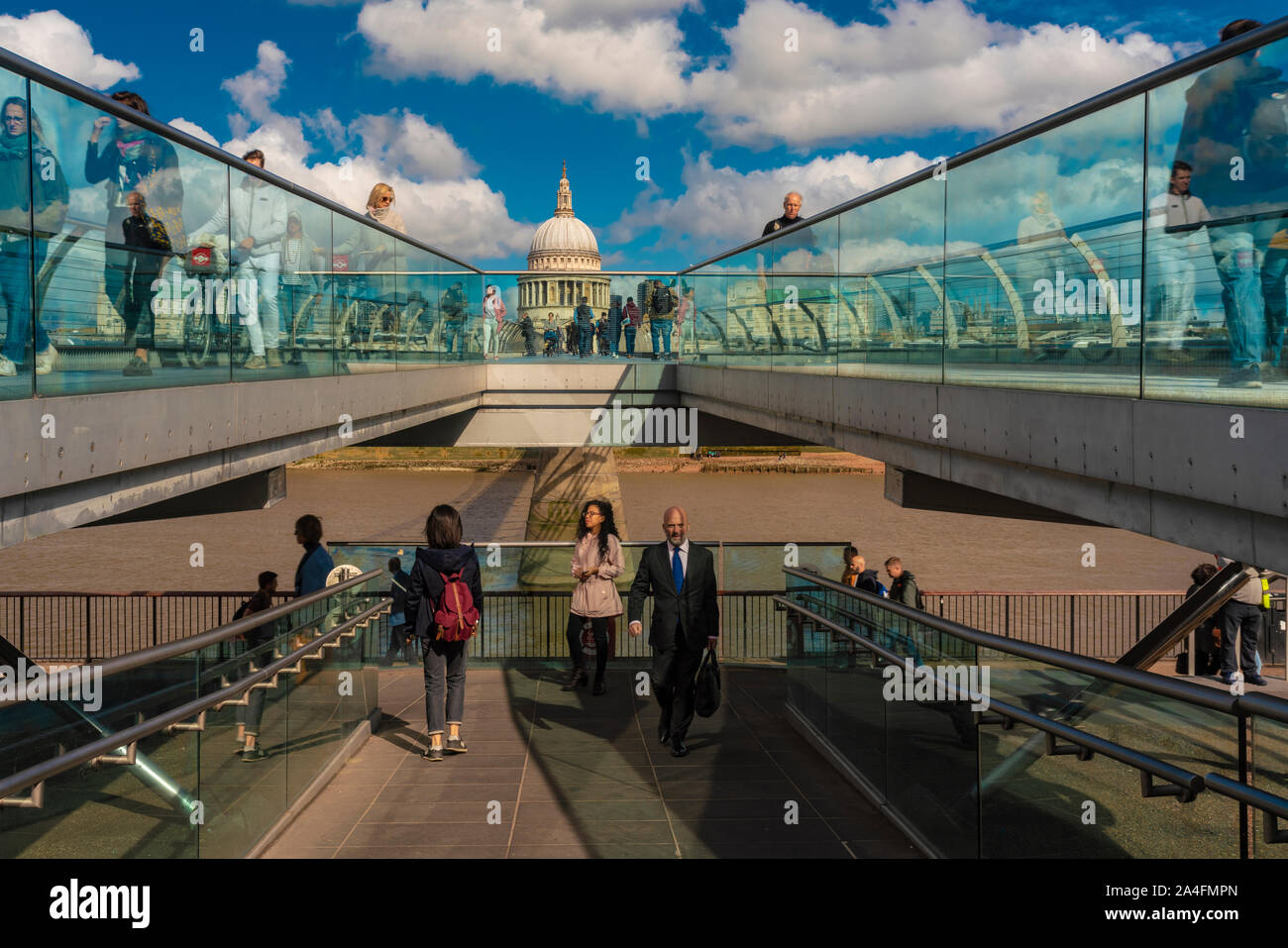 The millenium bridge with crowds of pedesterians and st paul Stock ...