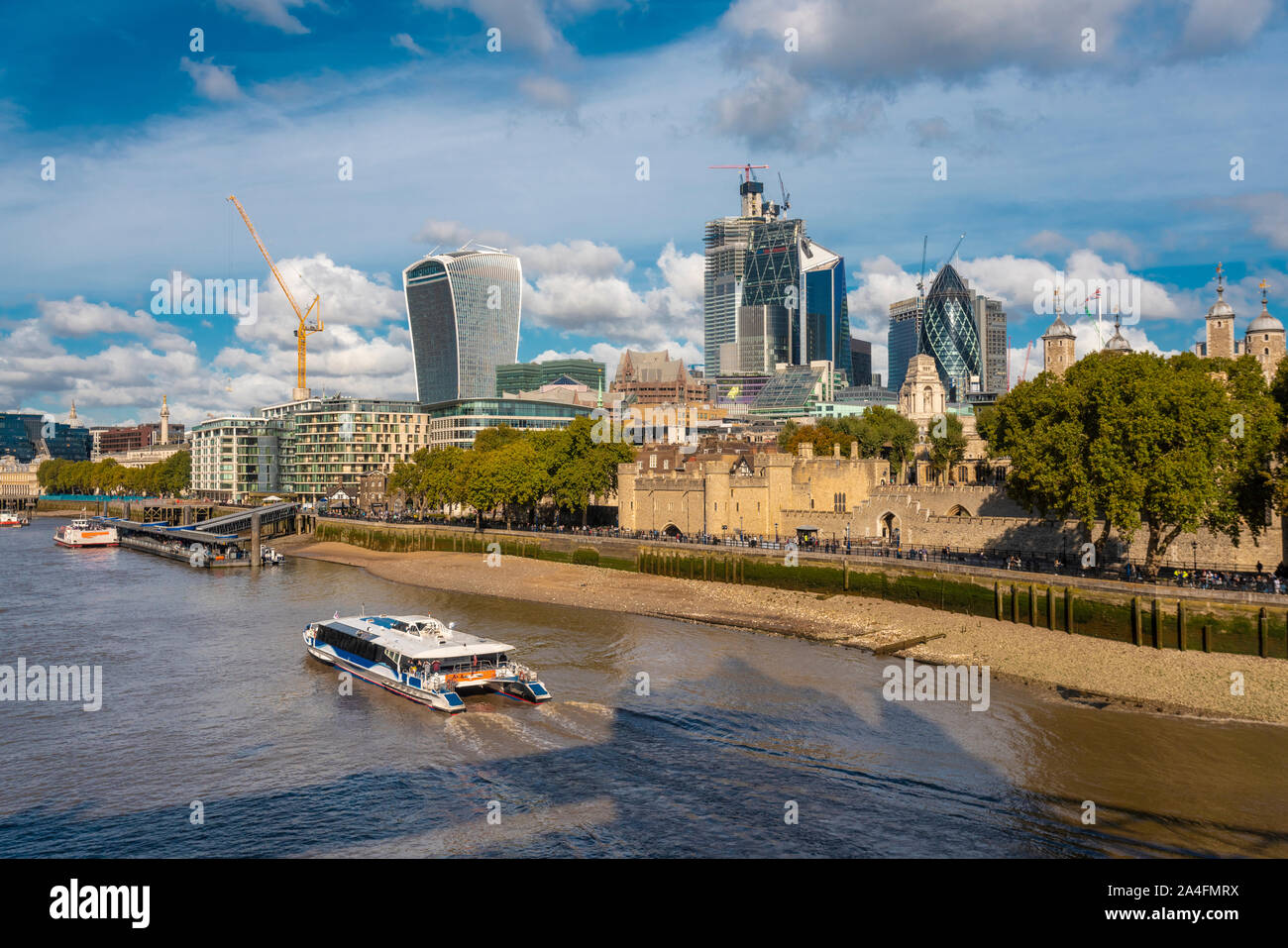 Cityscape of the city of London with blue clowdy sky with a ferry Stock ...