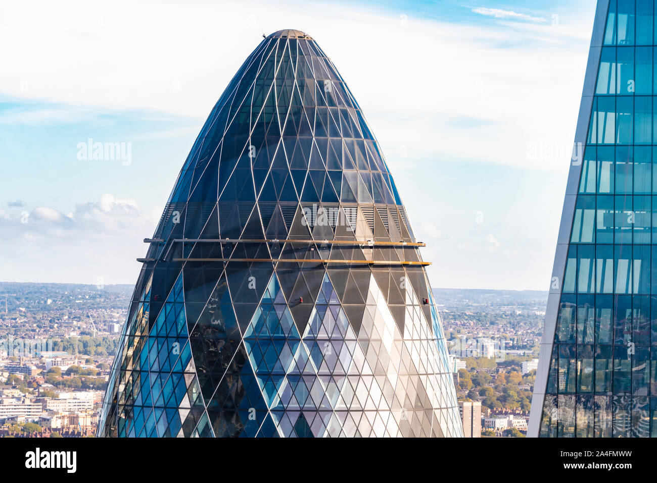 Detail of the Gherkin tower exterior with blue sky Stock Photo - Alamy