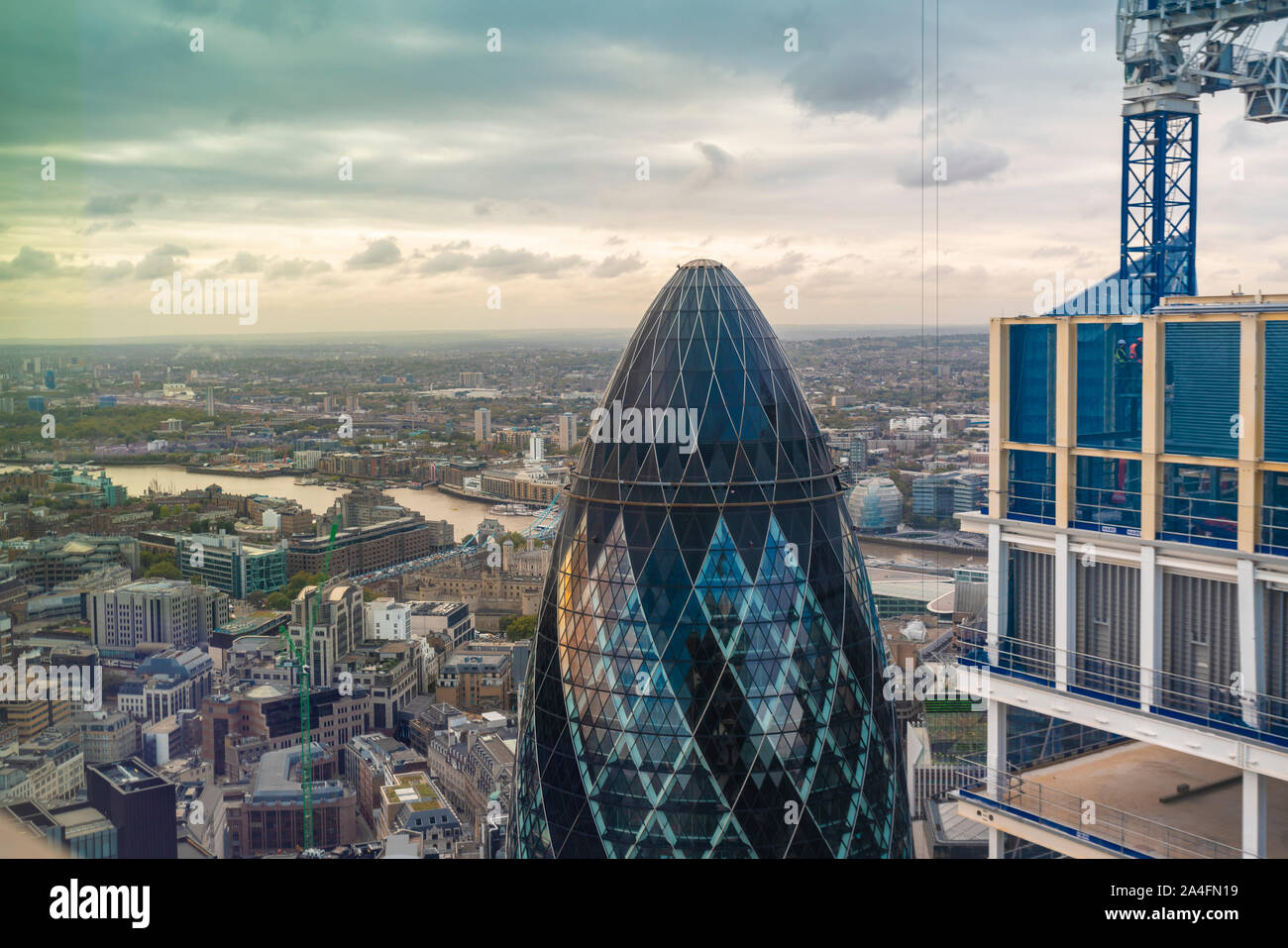 The Gherkin tower seen from above with Thames river on the background ...