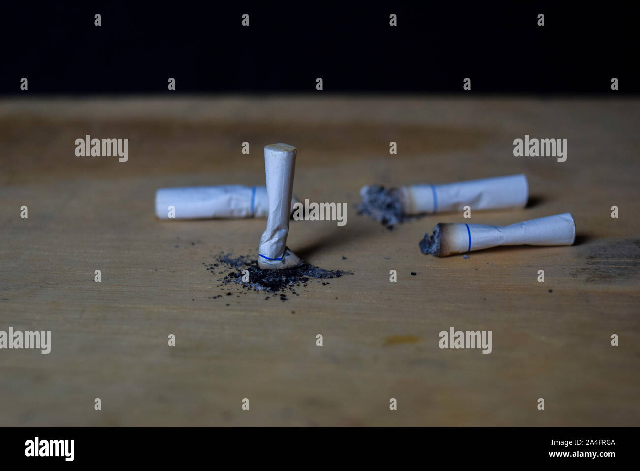 cigarettes on wooden table with black background. Smoking cigarettes ...