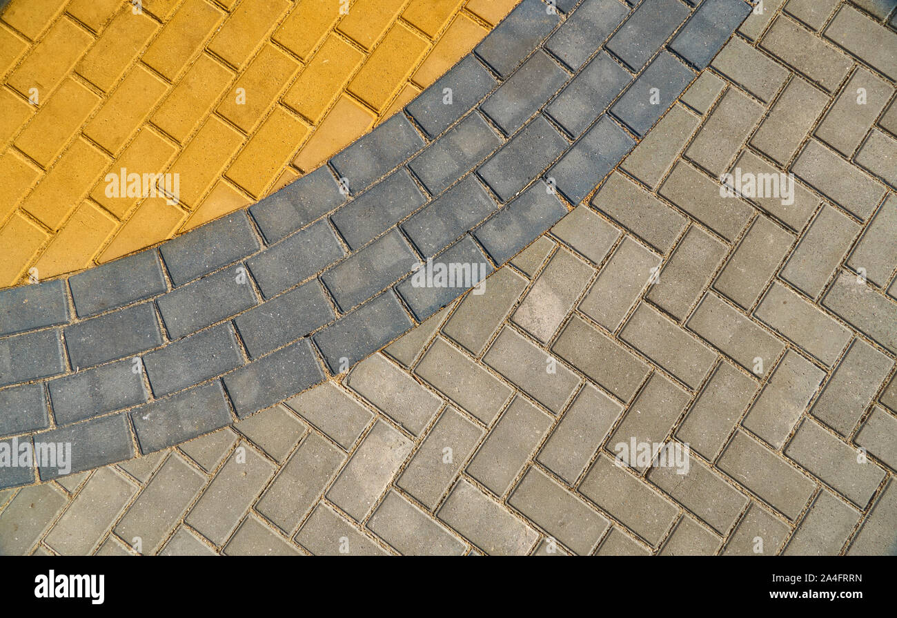 yellow and grey paving tiles for background or texture Stock Photo - Alamy