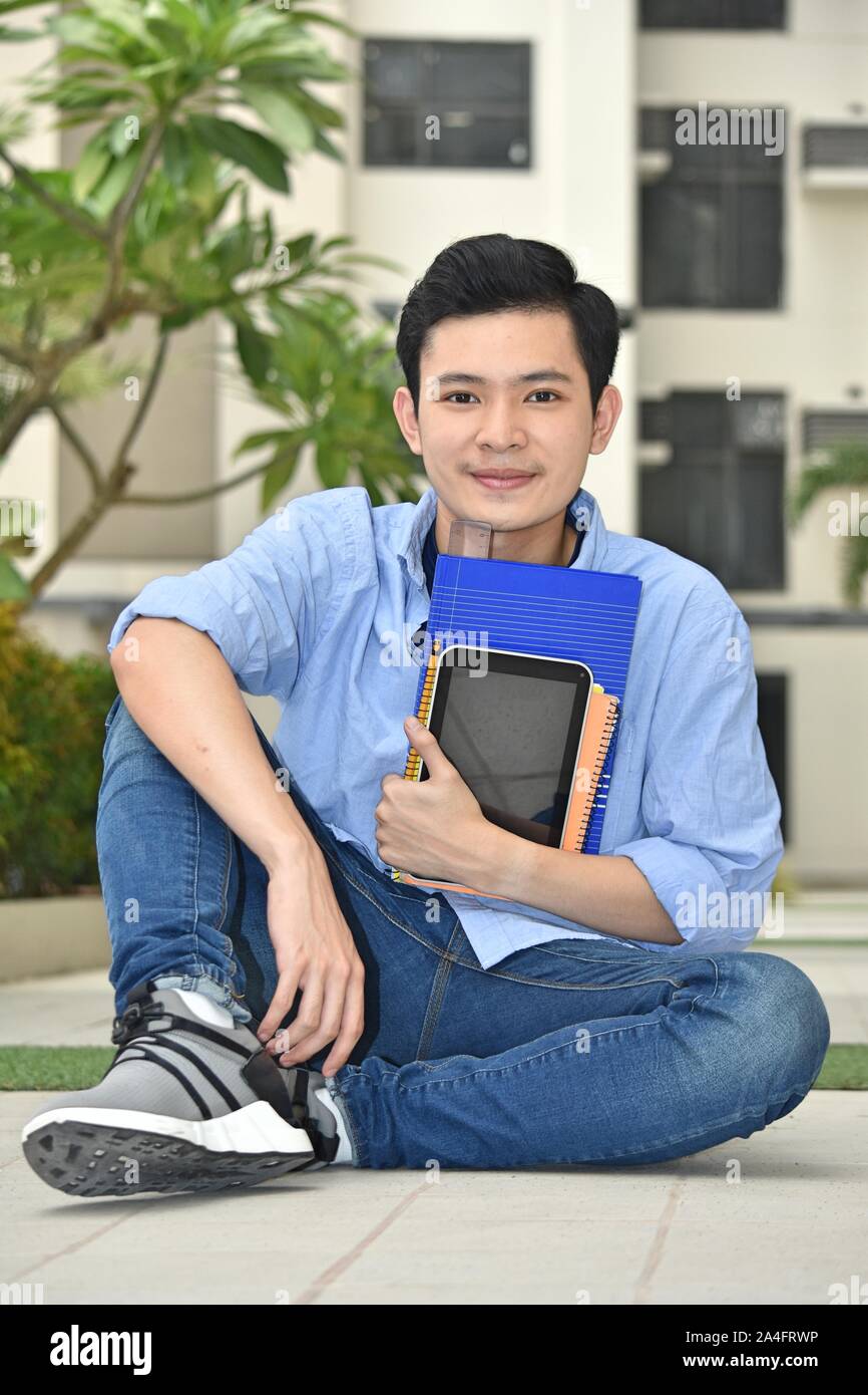 Student And Happiness With Books Sitting On Campus Stock Photo - Alamy