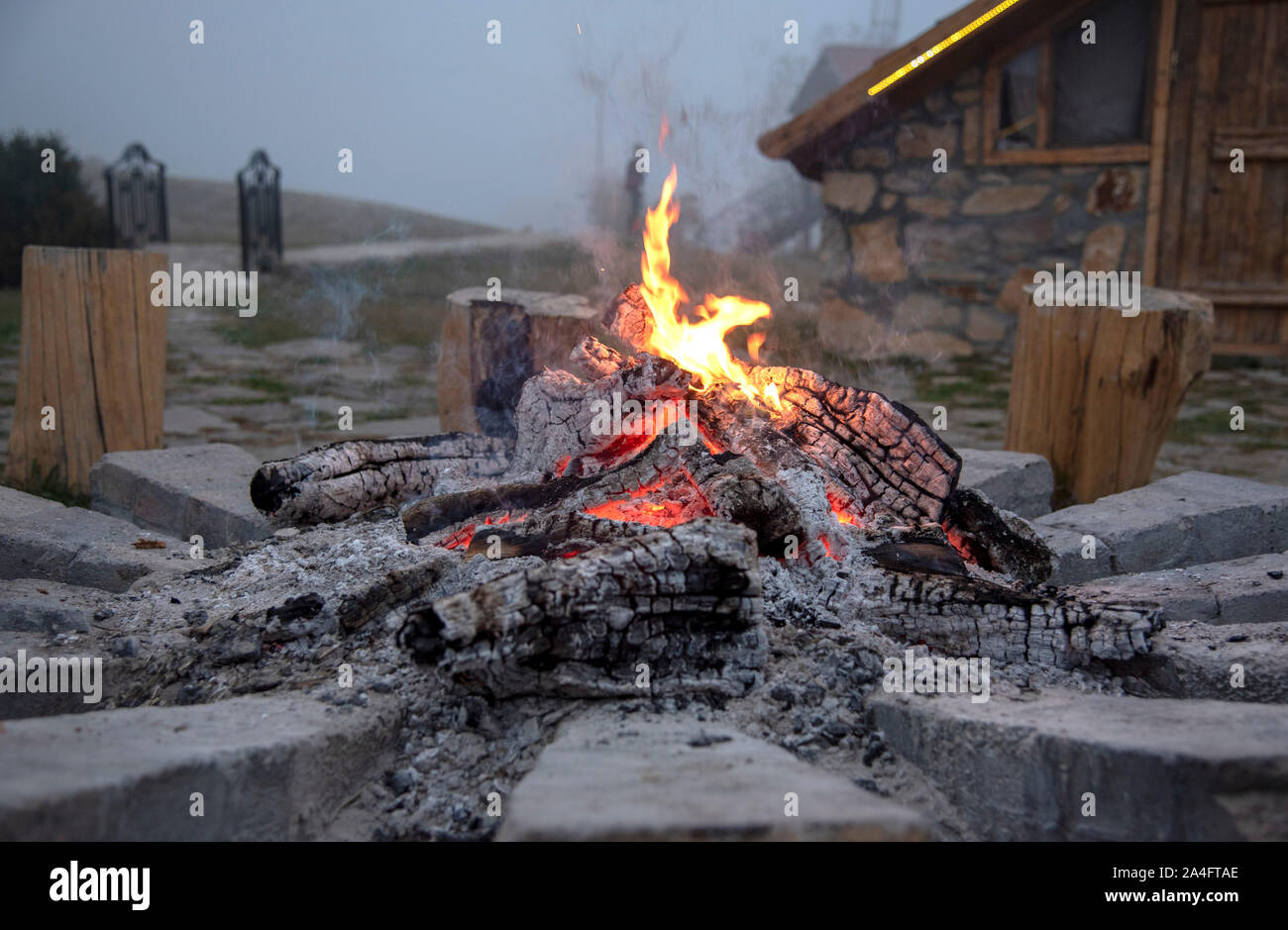 Bonfire, burning woodpile and round of stones, campfire or fireplace ...
