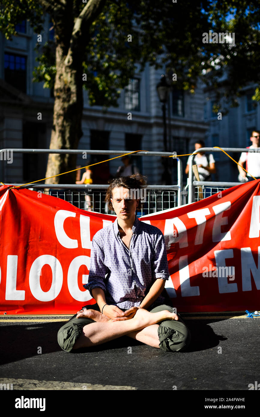 London, UK. A protester sits and meditates with his legs crossed during ...