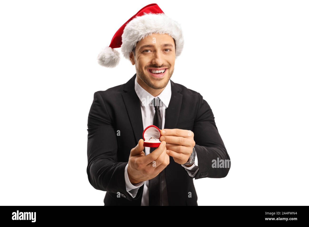 Young man proposing with a ring on Christmas isolated on white ...