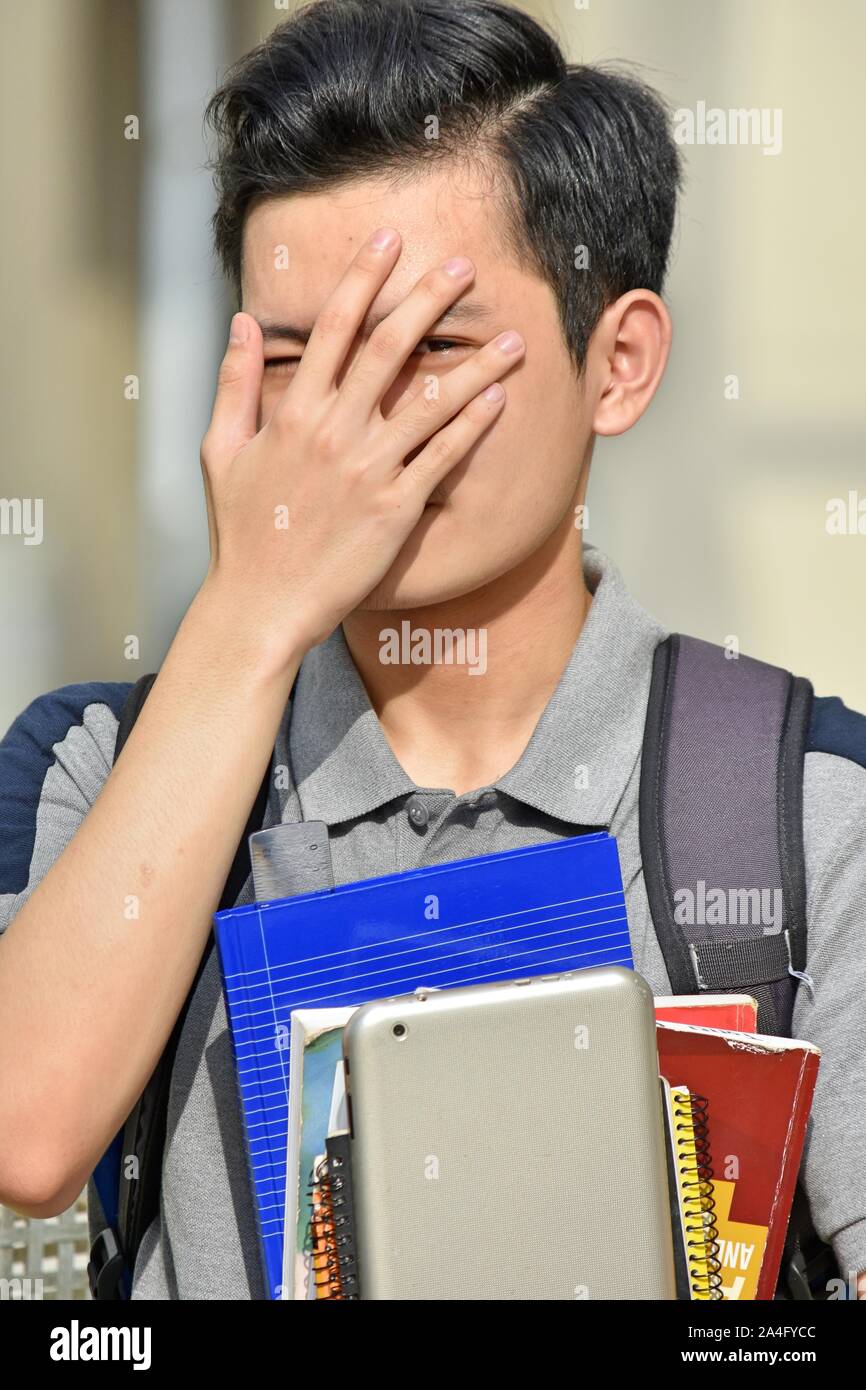 An Ashamed Boy Student With Notebooks Stock Photo - Alamy