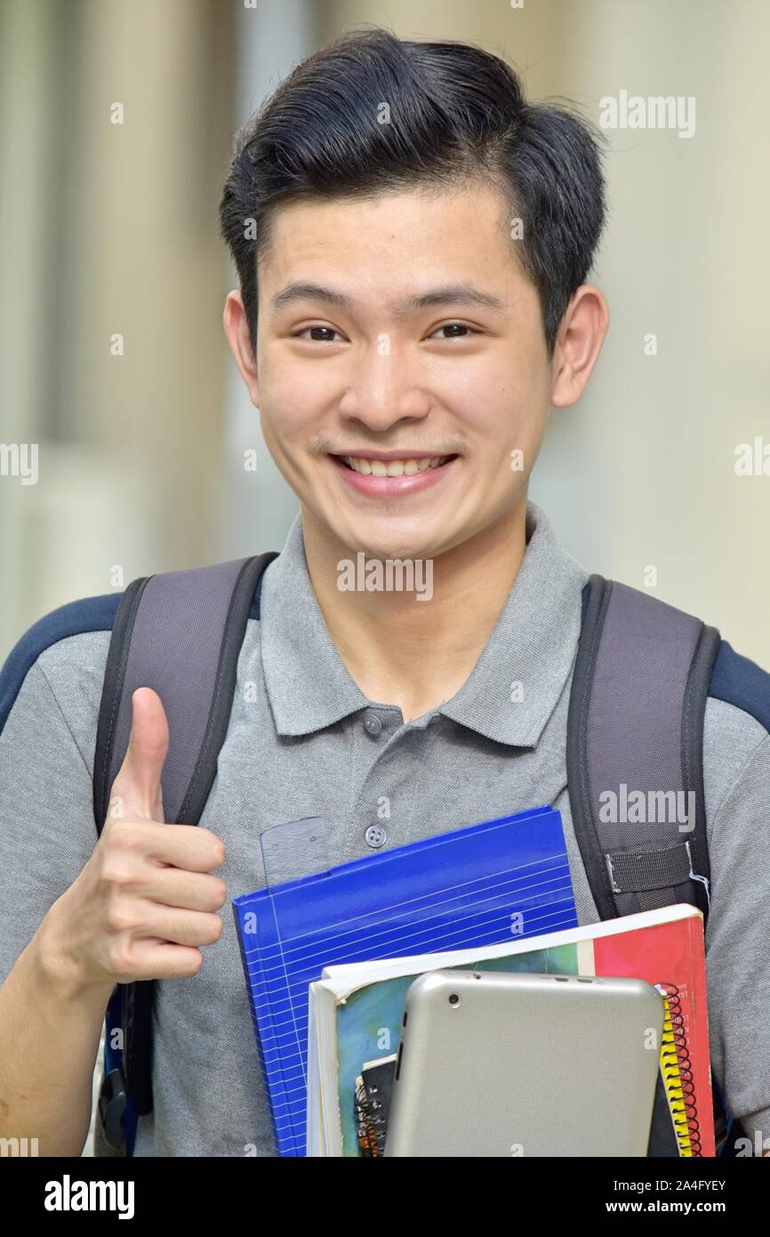 Boy Student With Thumbs Up With Books Stock Photo - Alamy