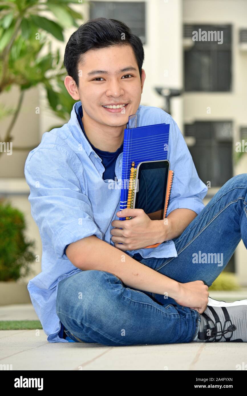 Smiling Chinese Boy Student With Notebooks Sitting Stock Photo - Alamy