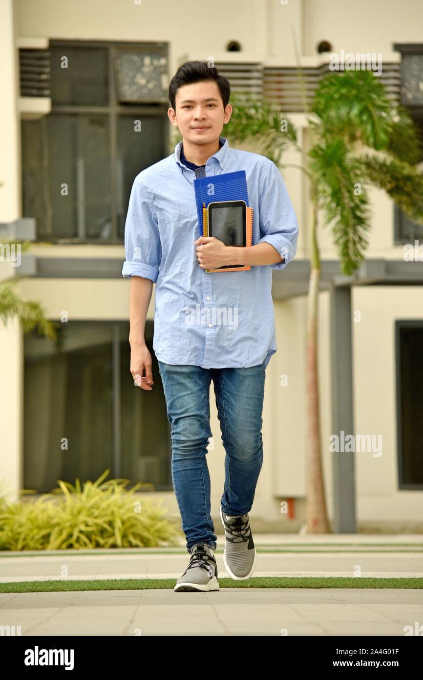 Smart Male Student Walking Stock Photo - Alamy