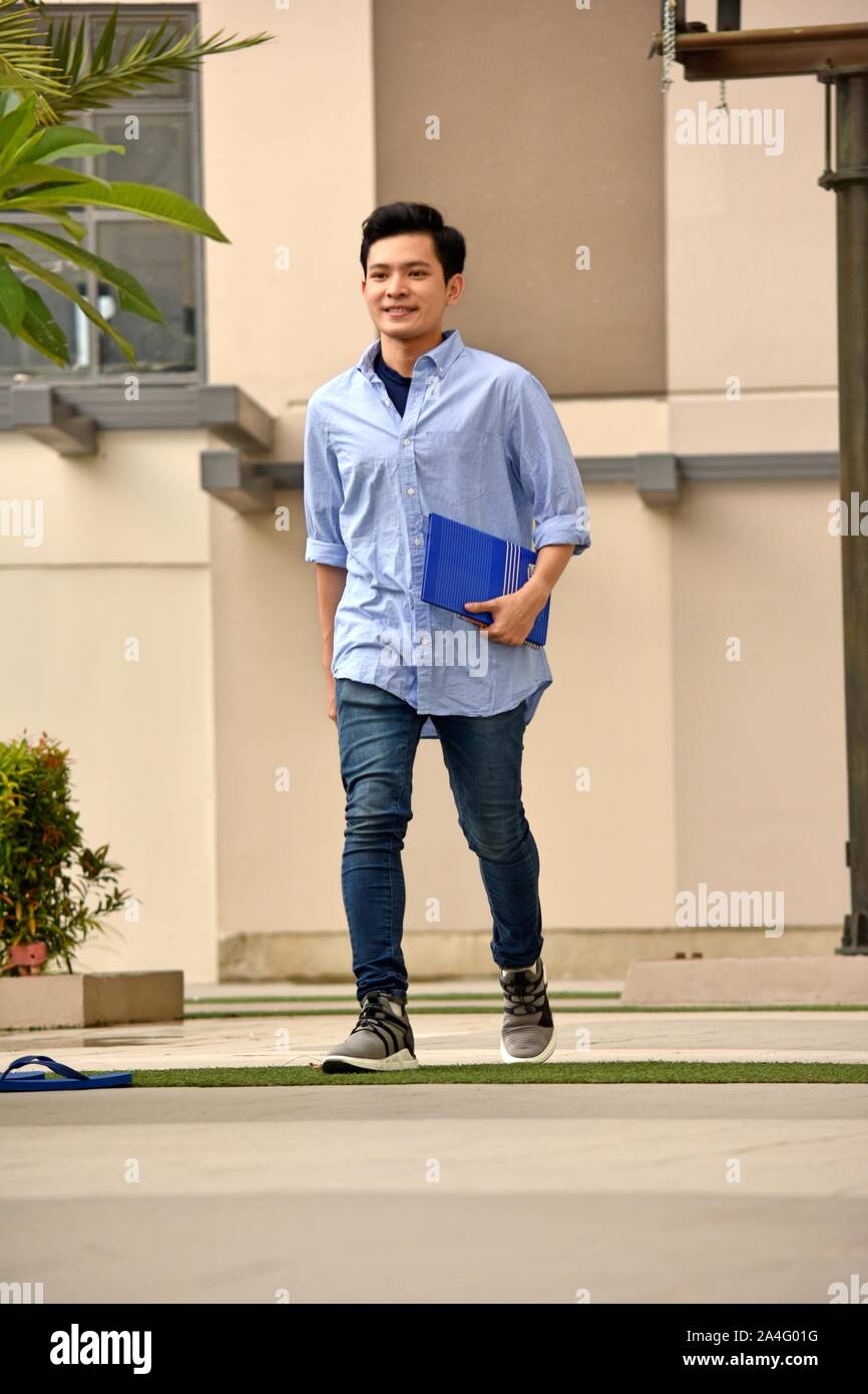 Smart Diverse Male Student With Notebooks Walking On Campus Stock Photo ...