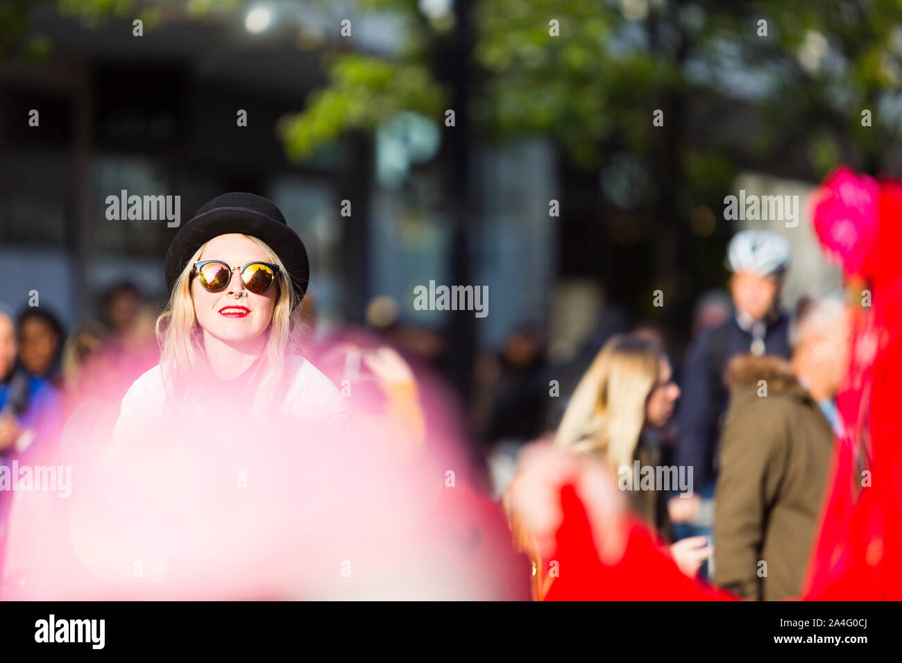 London, UK. A protester wearing sunglasses and wearing a top hat on ...