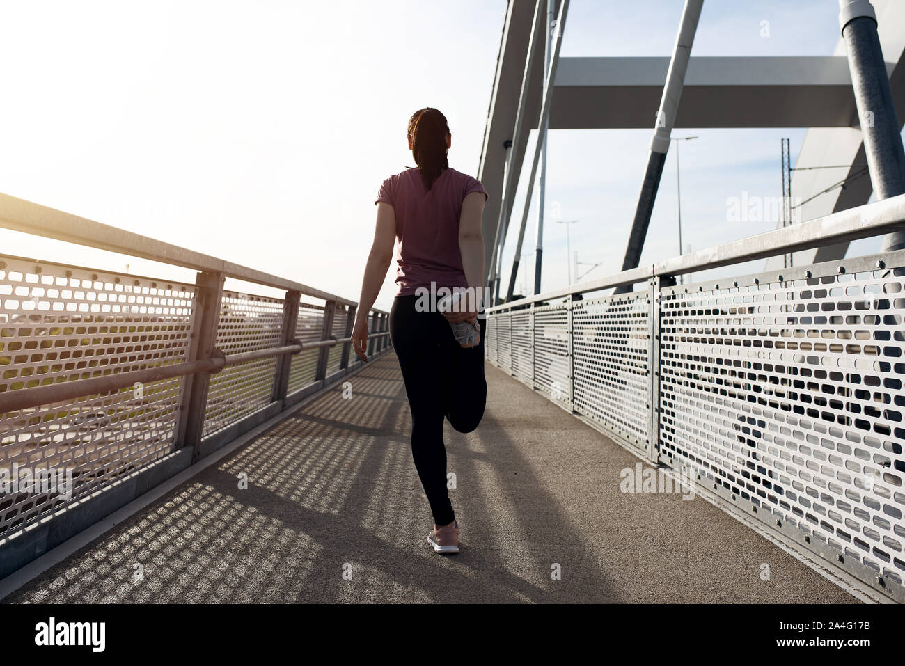 Sunset exercise with beautiful, sport woman. Female runner listening to ...