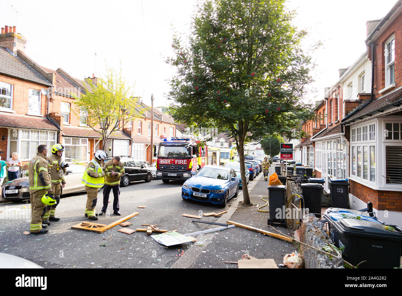 Firefighters survey wreckage lying in the street at Foxley Gardens ...