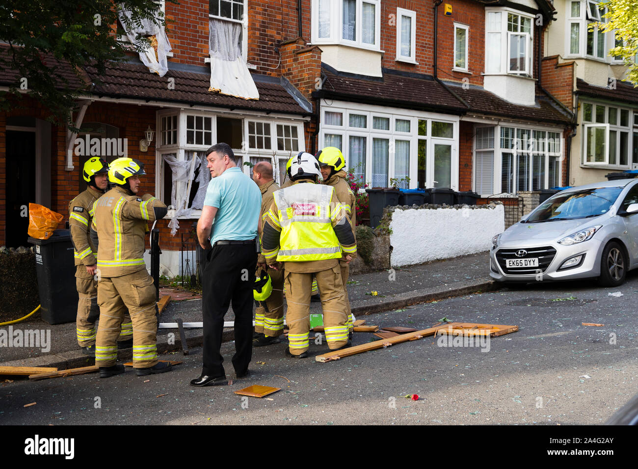 Firefighters survey wreckage lying in the street at Foxley Gardens ...