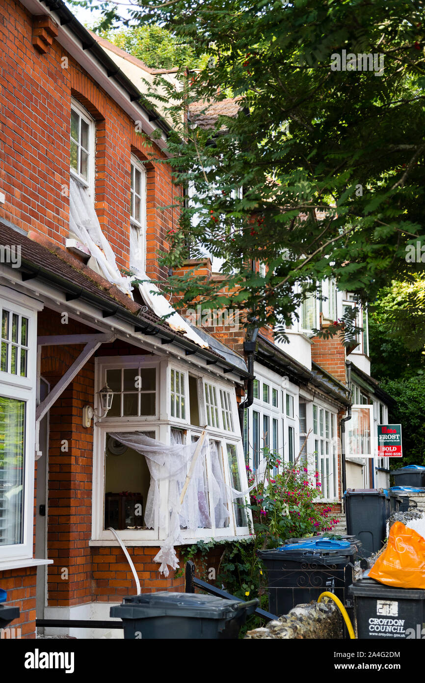 A set of living room windows lean dangerously out of the wall of a ...