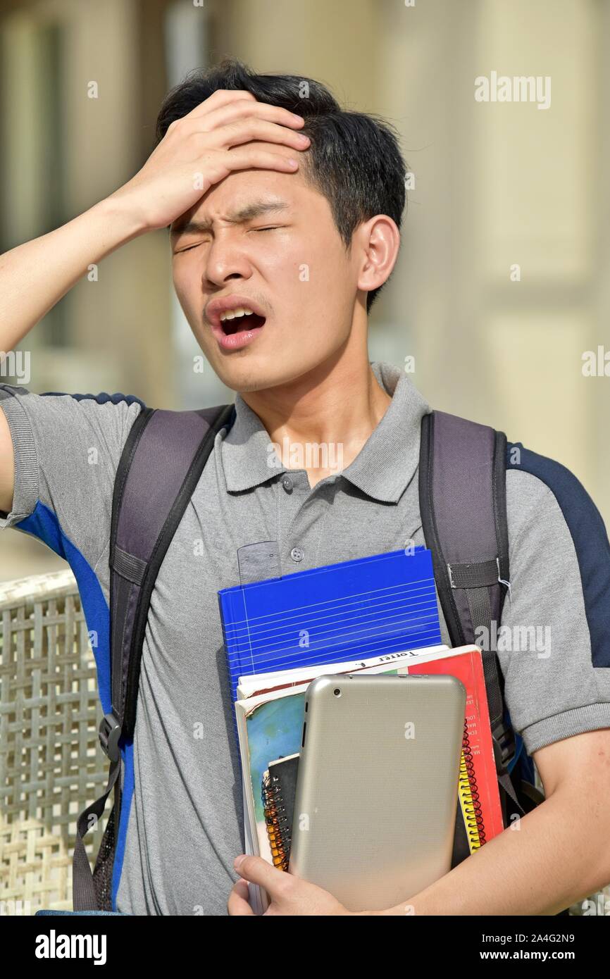 Young Chinese Male Student With Fever With Notebooks Stock Photo - Alamy