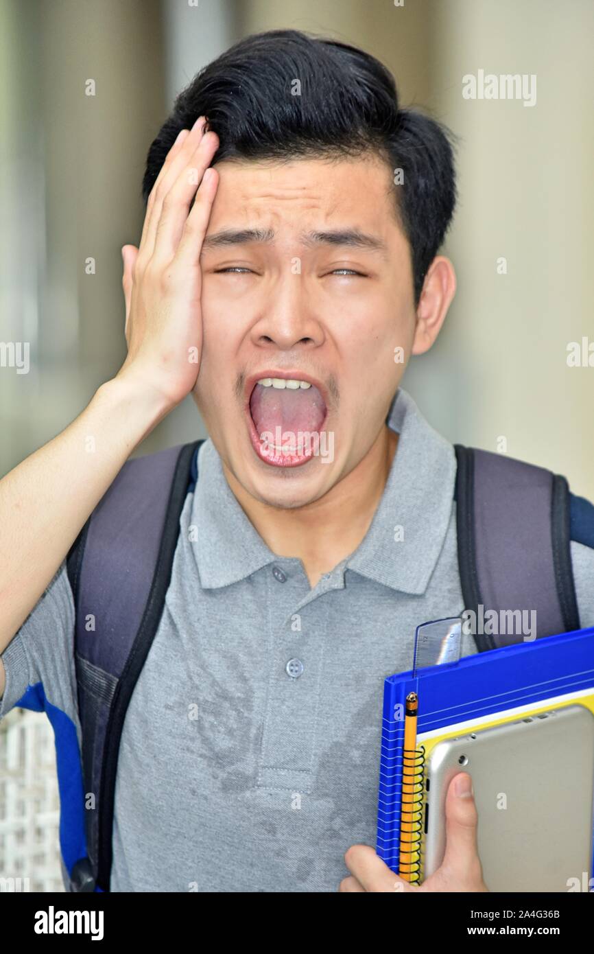 Forgetful Male Student With Books Stock Photo - Alamy