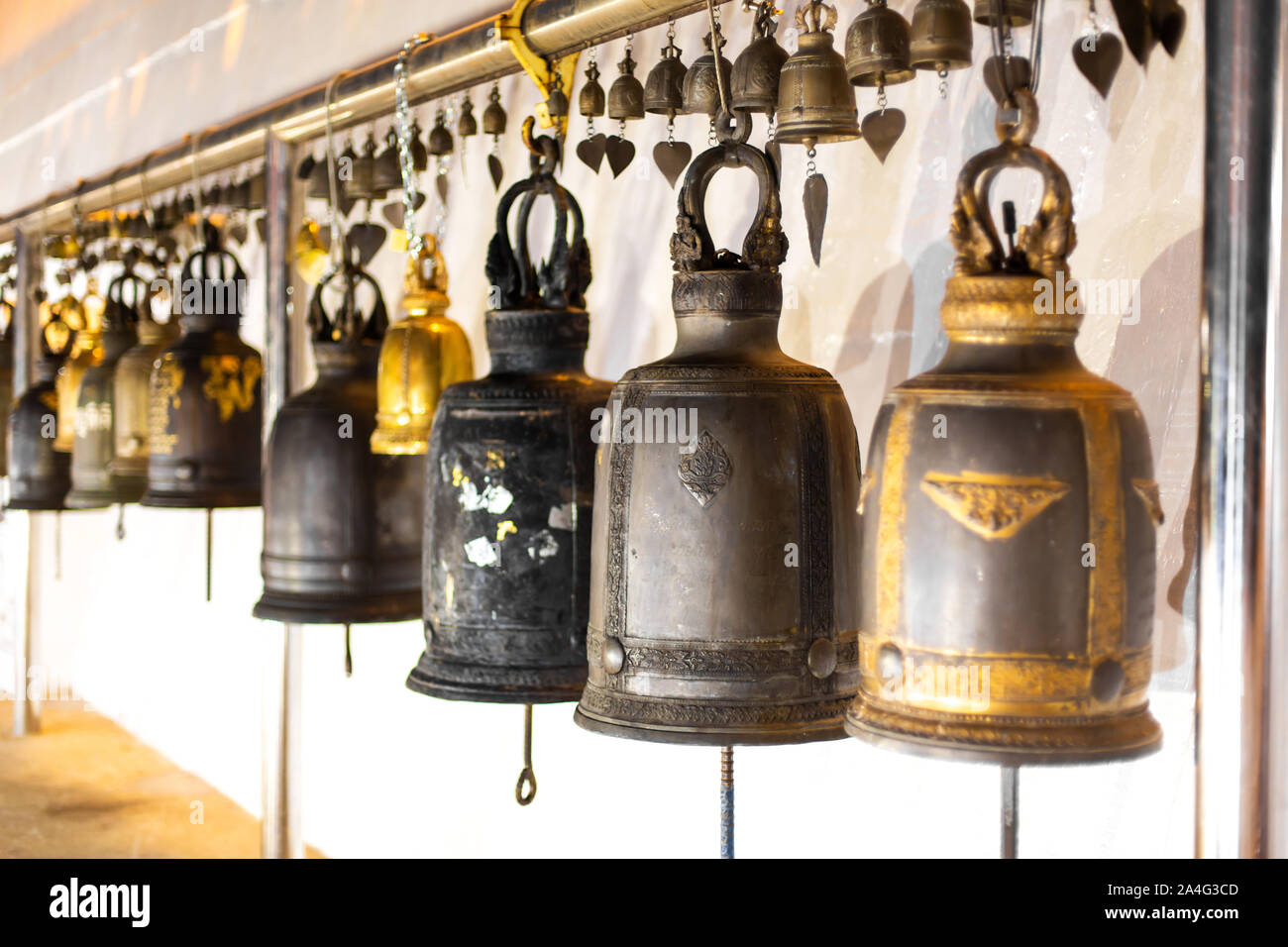 Ritual bells of different sizes in a Buddhist temple Stock Photo - Alamy