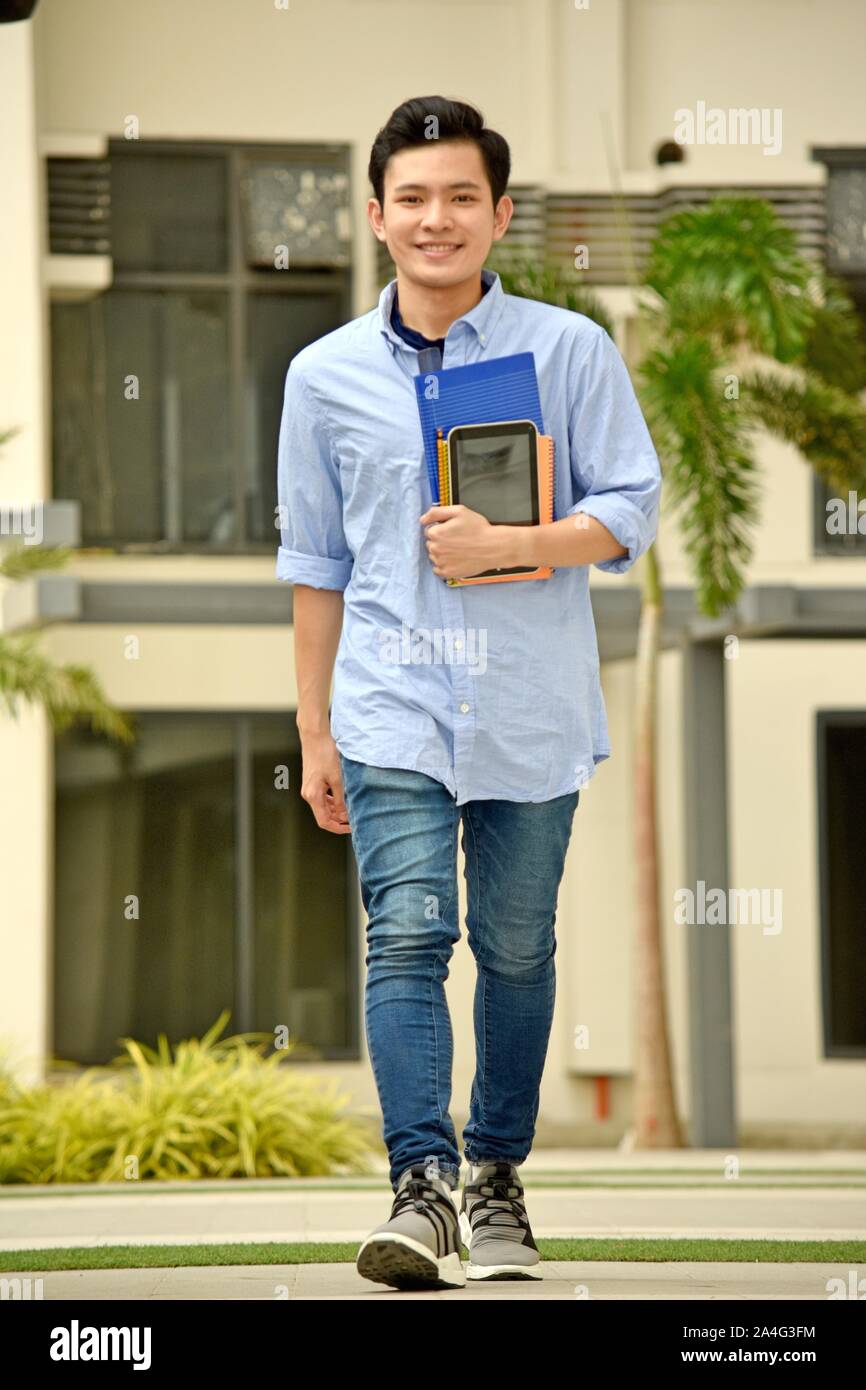 Smiling Handsome Asian Boy Student With Notebooks Walking Stock Photo ...