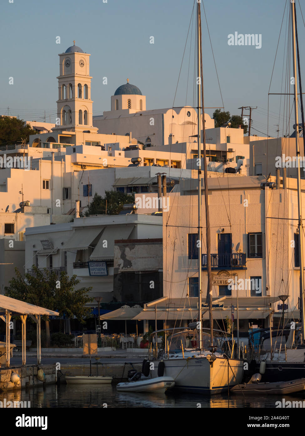 a close up view of Milos harborside harbourside quay in a yellow dusk ...