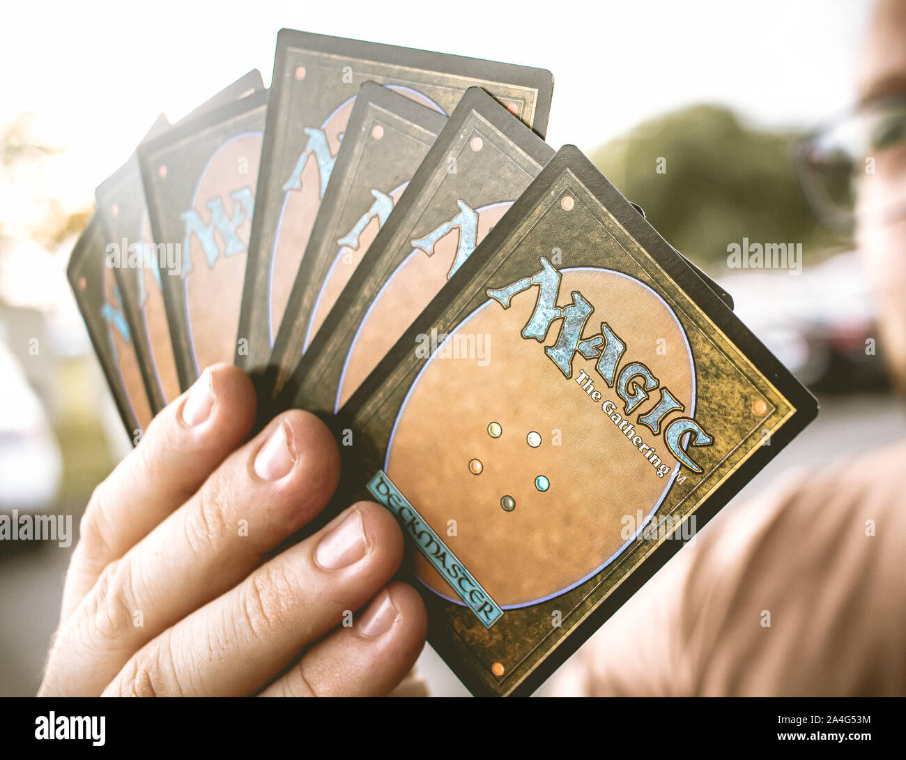 Man holding up game cards: "Magic: the Gathering Stock Photo - Alamy