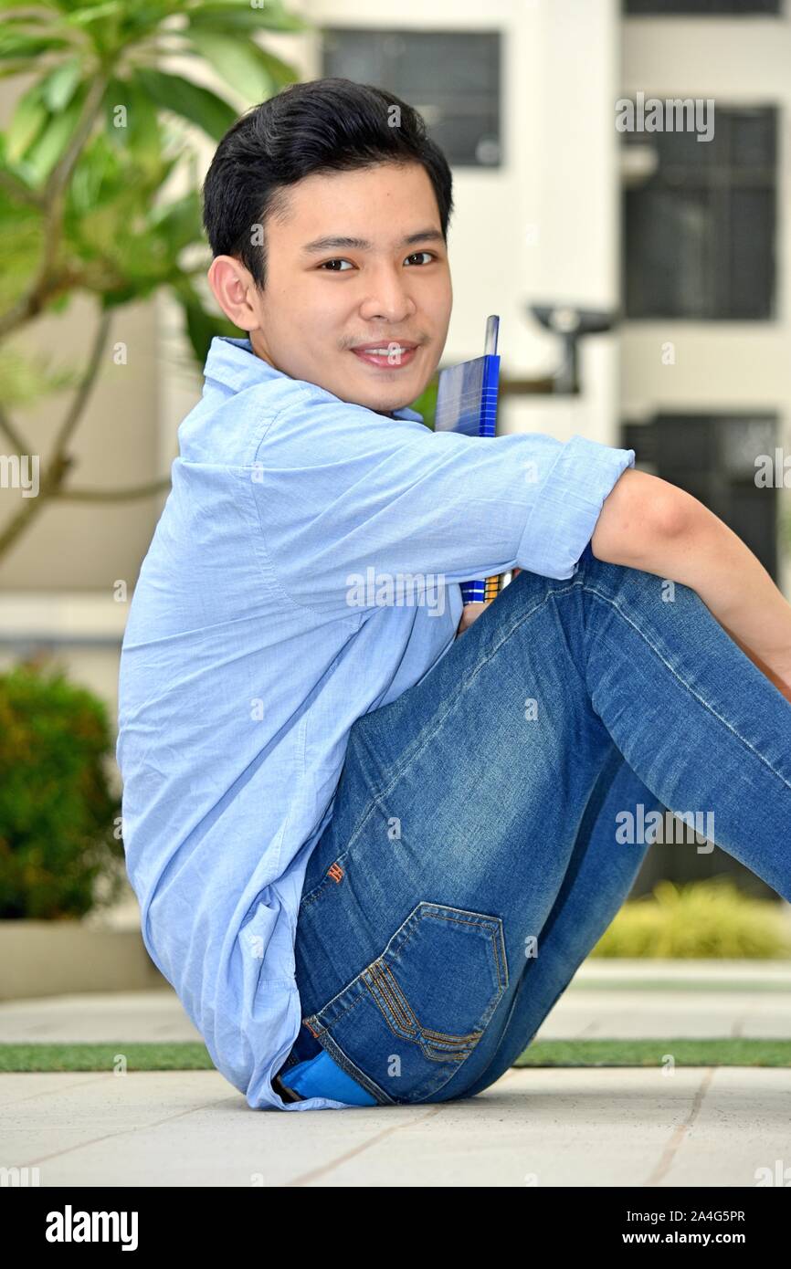 Happy Handsome Filipino Student With Books Sitting Stock Photo - Alamy