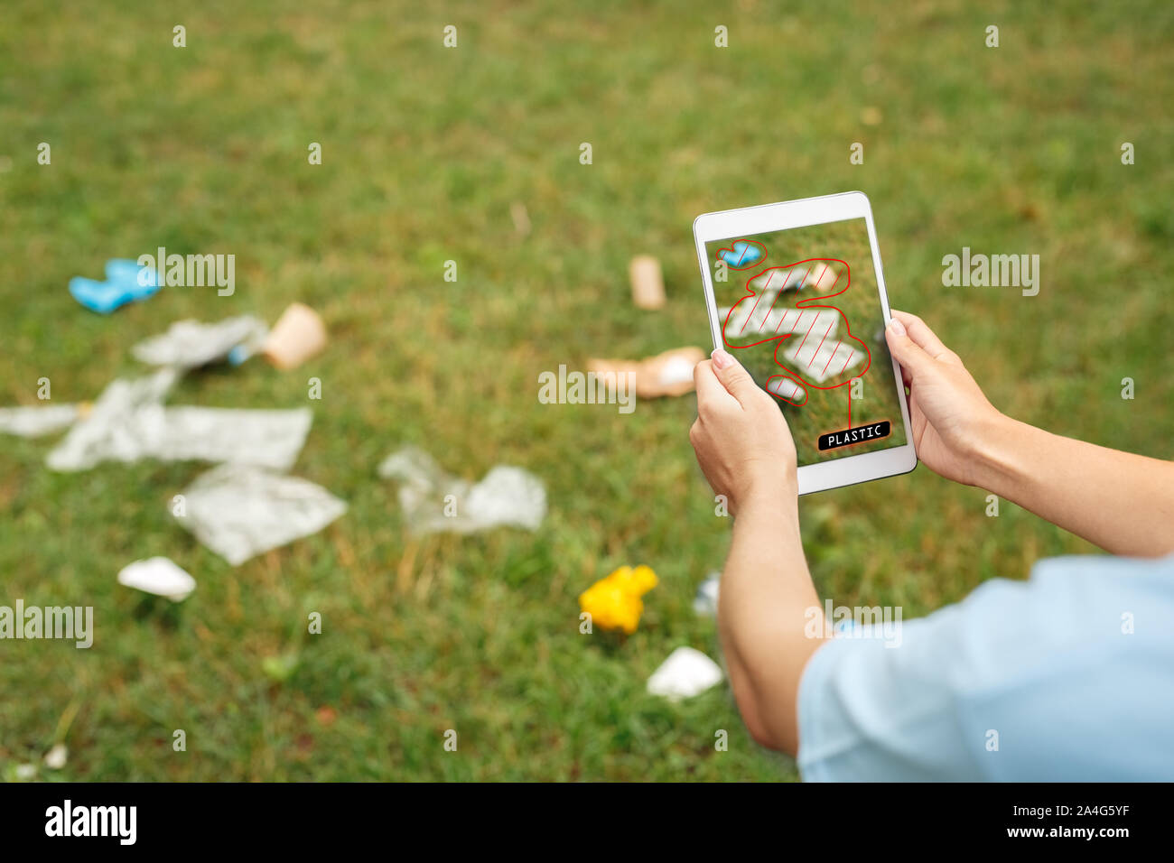 Waste Management. Young girl sitting a park holding smartphone using ...