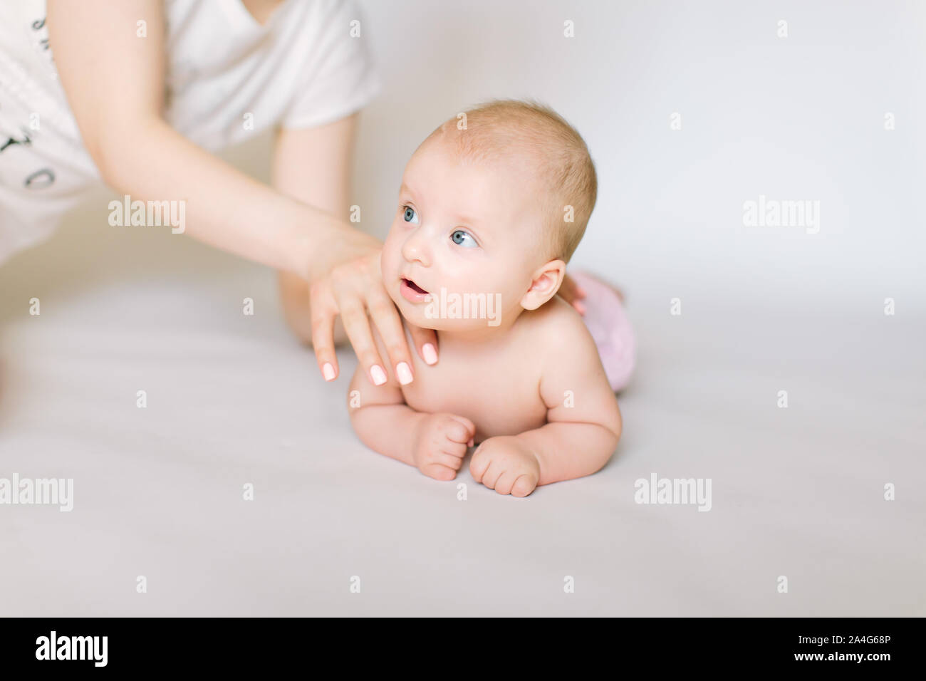 little baby massage back, isolated on white Stock Photo - Alamy