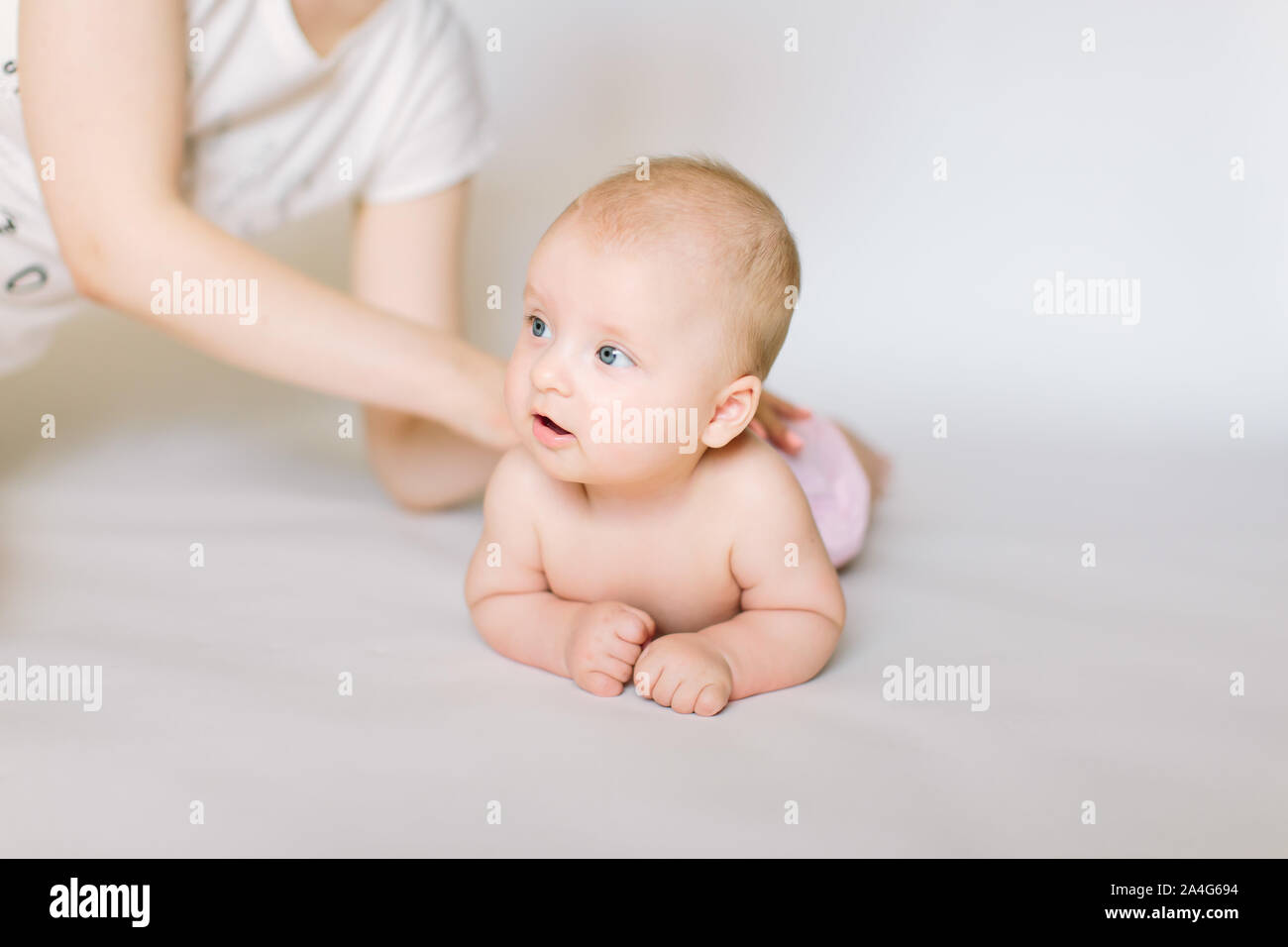 little baby massage back, isolated on white Stock Photo - Alamy