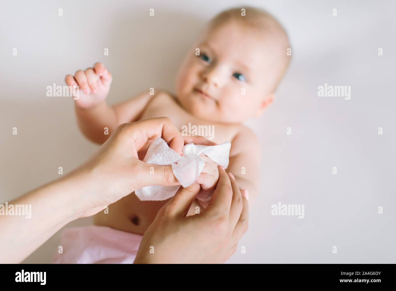 Mother Wiping Baby's hands Stock Photo - Alamy