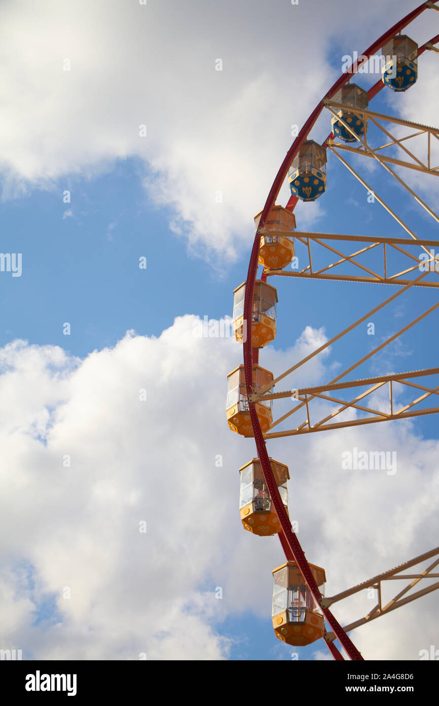 Close up modern Ferris wheel against blue sky and white clouds, fun ...