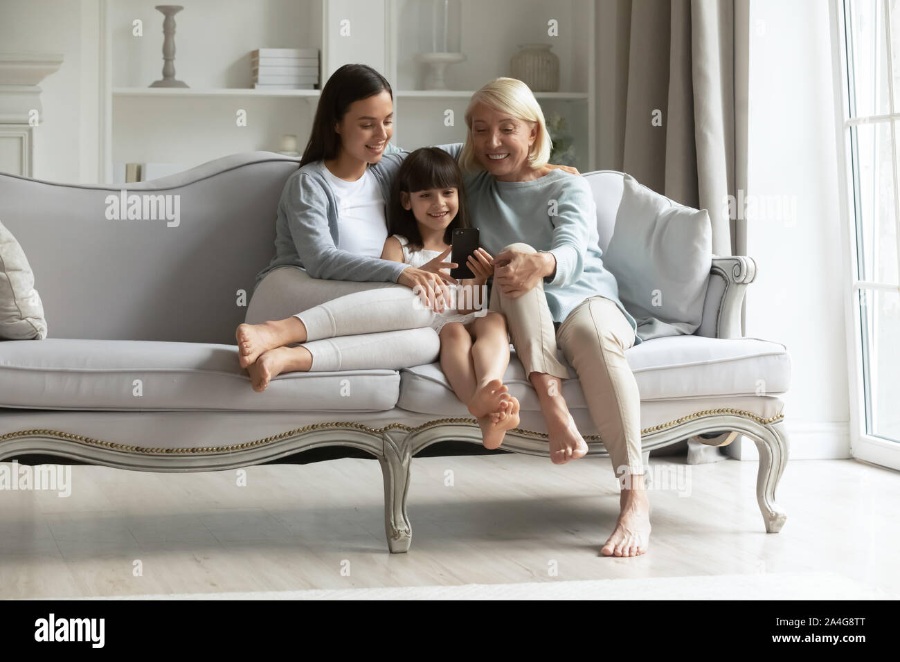 Full length happy 3 generations family enjoying free time together ...