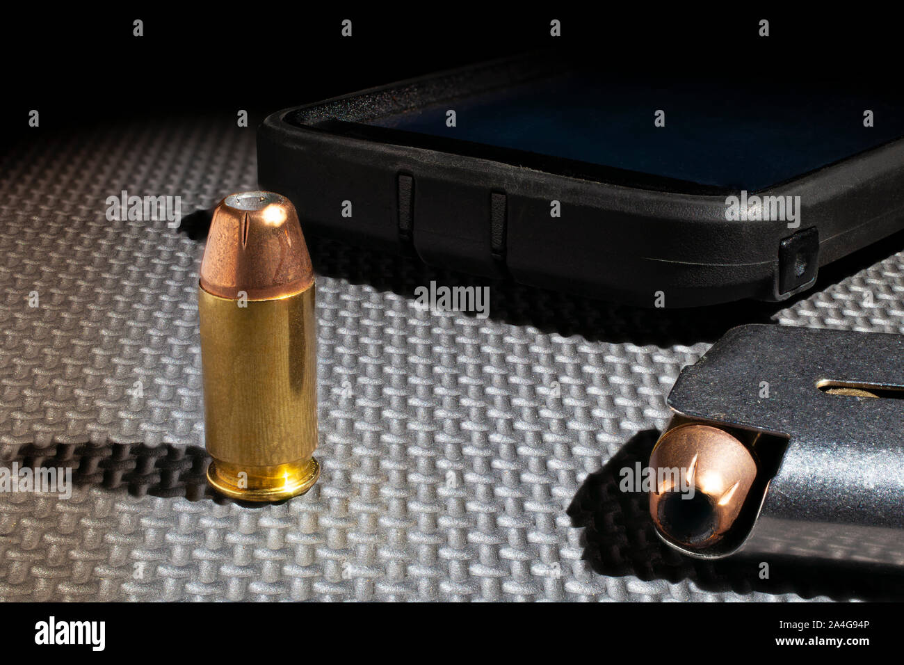 Smart phone next to ammunition and a pistol magazine Stock Photo - Alamy