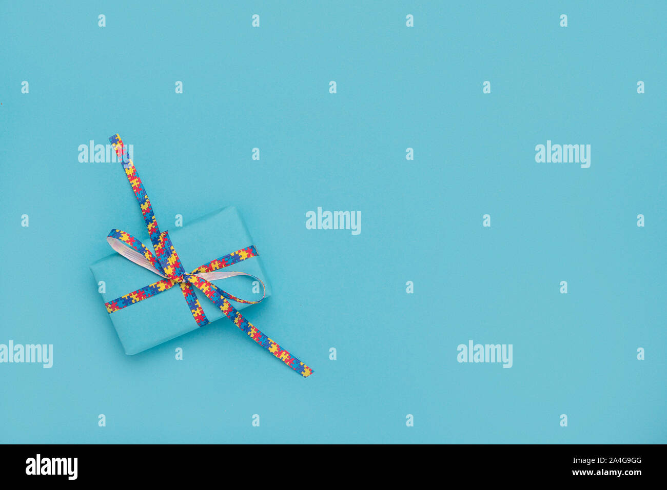 World Autism awareness blue background with gift, Puzzle pattern ribbon ...