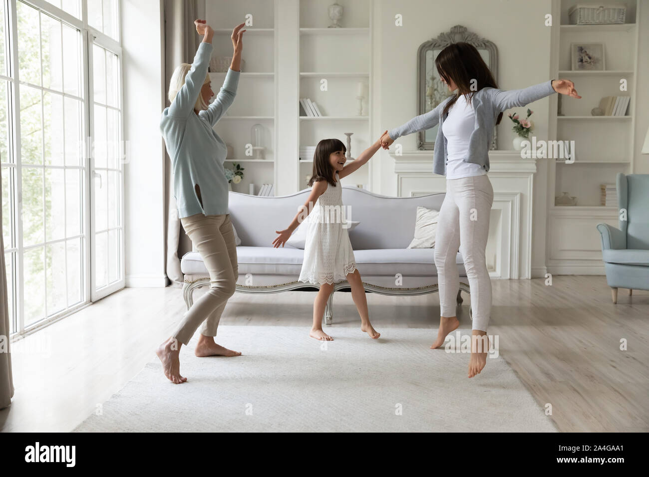 Full length happy 3 generations family having fun together in living ...